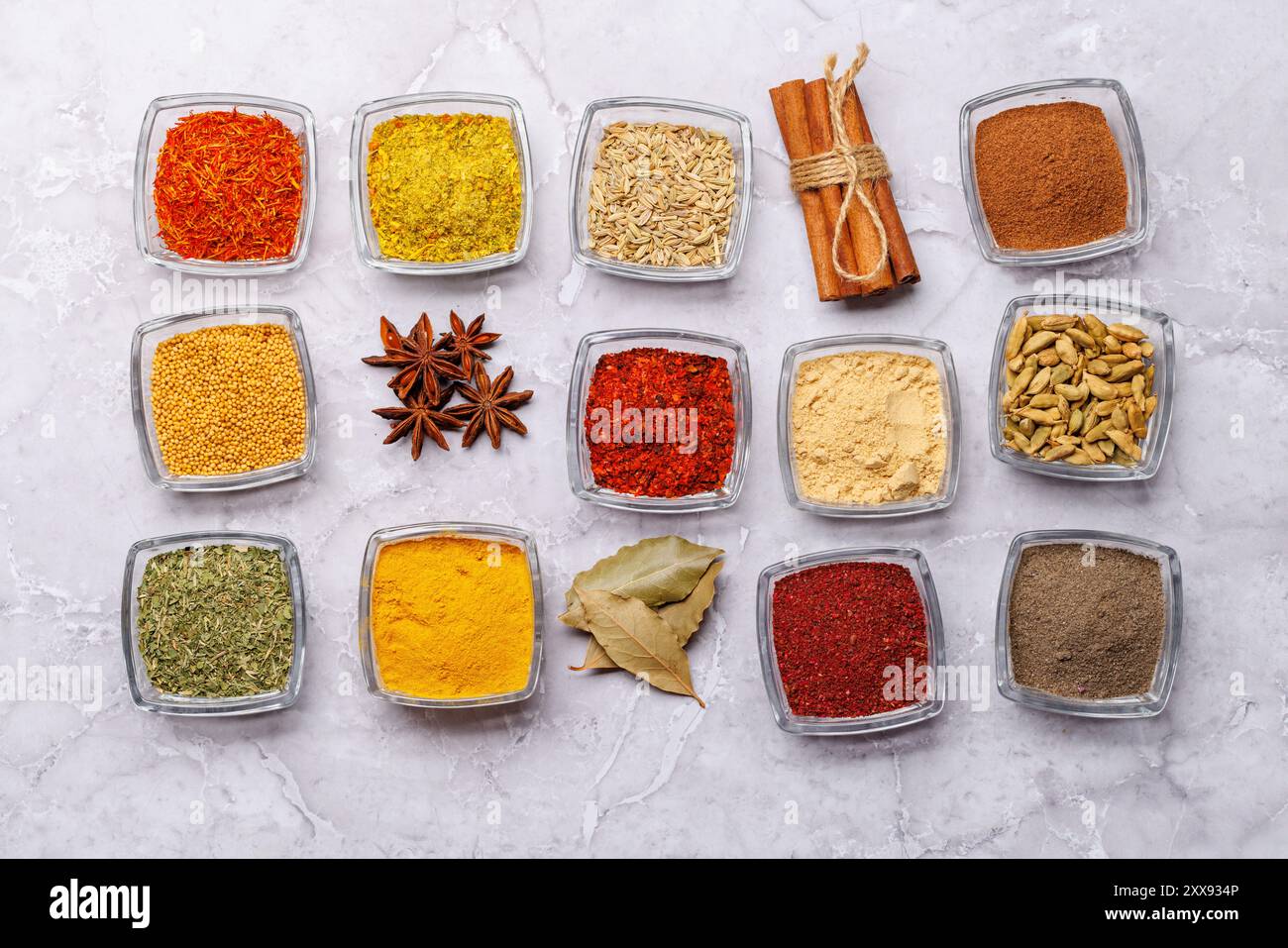 A vibrant assortment of various spices and herbs displayed together ...