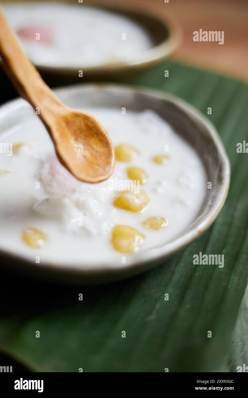 Thai glutinous rice balls with coconut milk on wood, Thai dessert Stock ...
