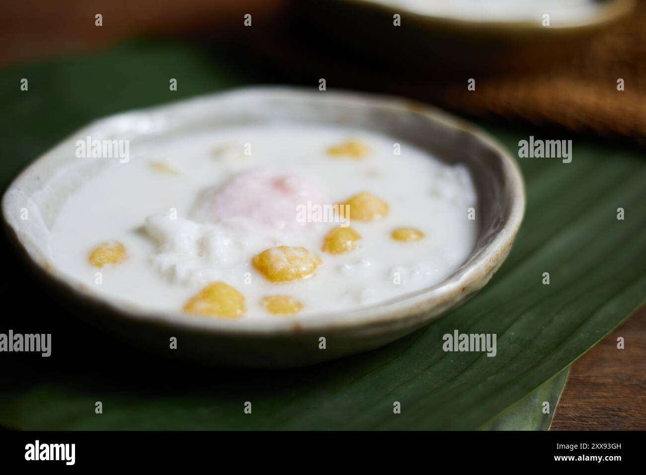 Thai glutinous rice balls with coconut milk on wood, Thai dessert Stock ...