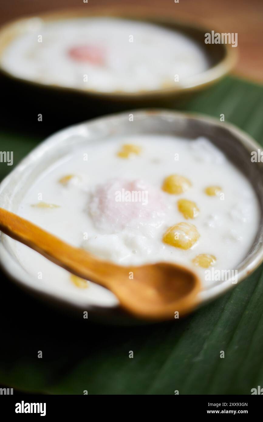 Thai glutinous rice balls with coconut milk on wood, Thai dessert Stock ...