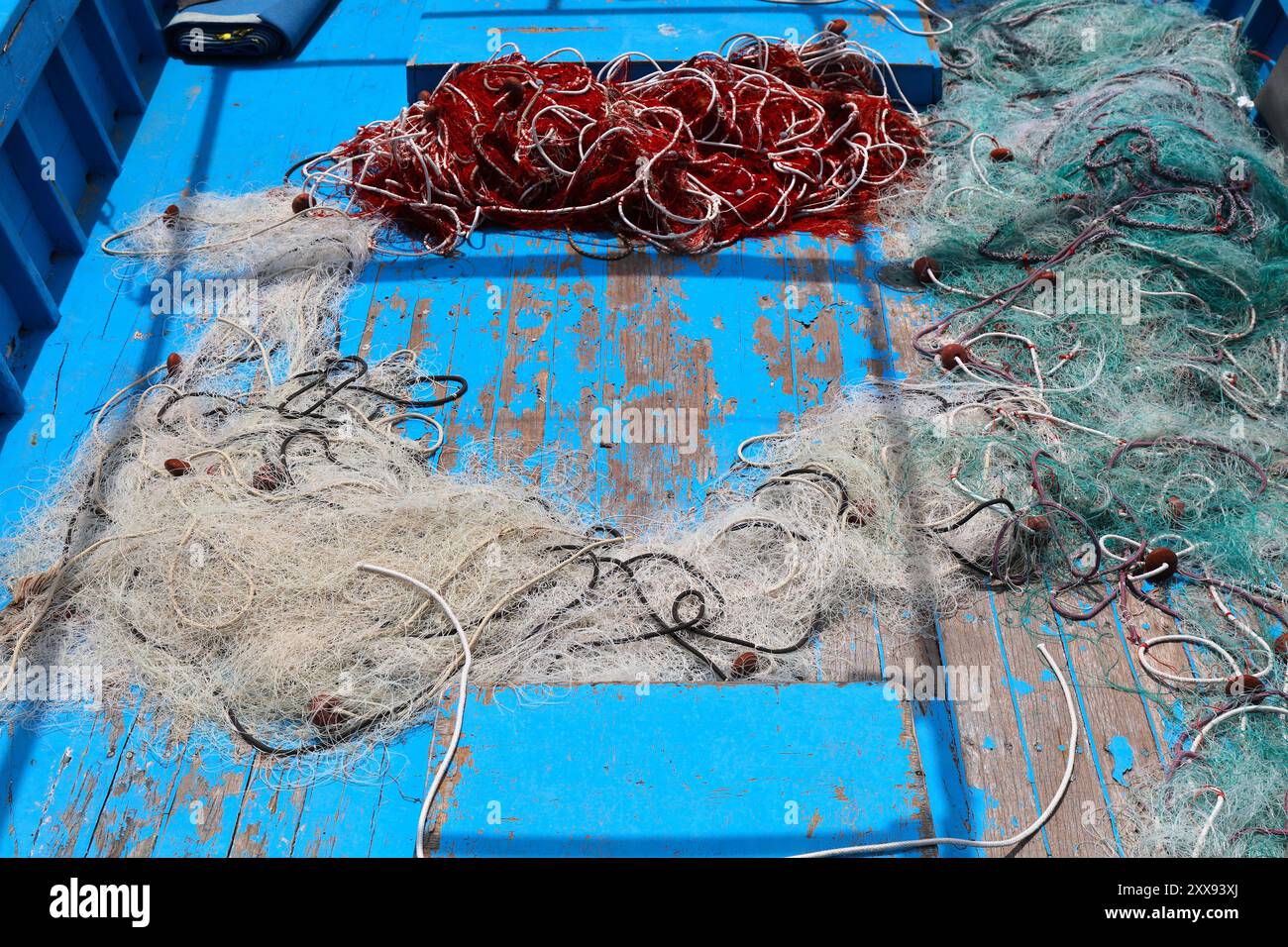 Fishing nets in a small fishing ship in Alghero harbor, Sardinia island ...