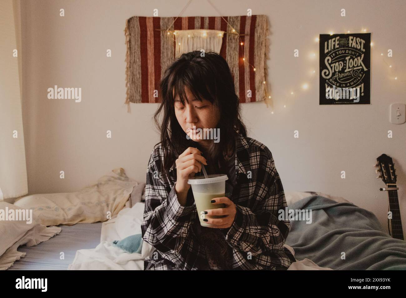 girl drinking matcha in bedroom tumblr Stock Photo - Alamy