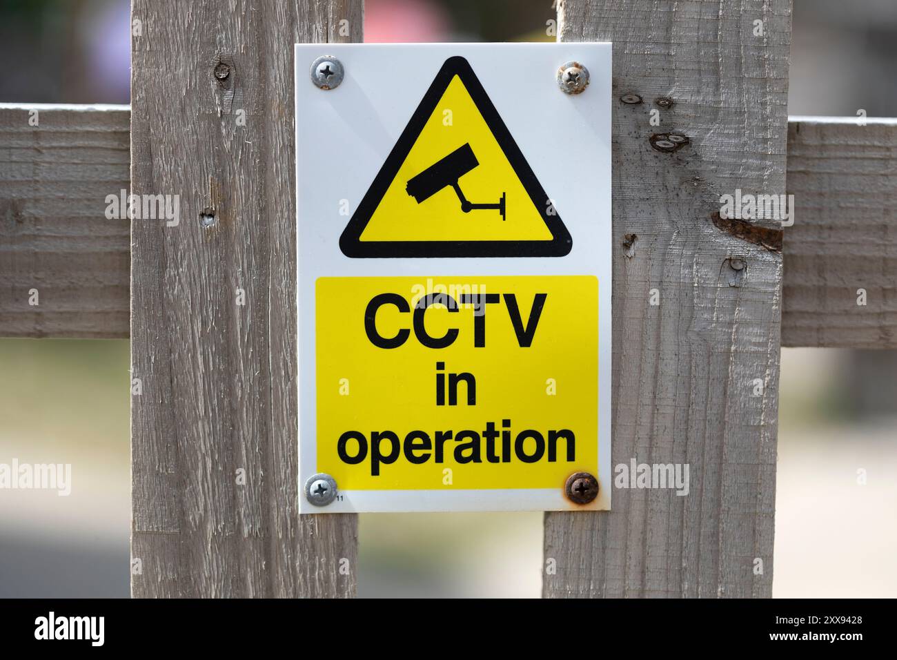 A CCTV in operation sign on a wooden fence Stock Photo - Alamy