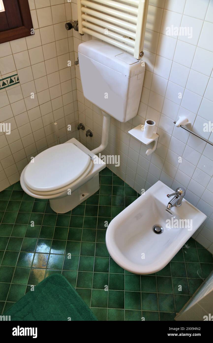 Bidet in a bathroom in Italy. Generic retro style Italian bathroom with ...