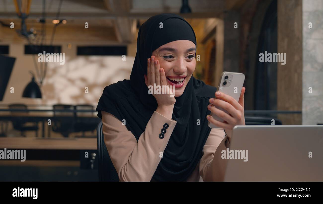 Happy excited joyful Arabian muslim business woman wonder amazement female islamic girl hijab ...