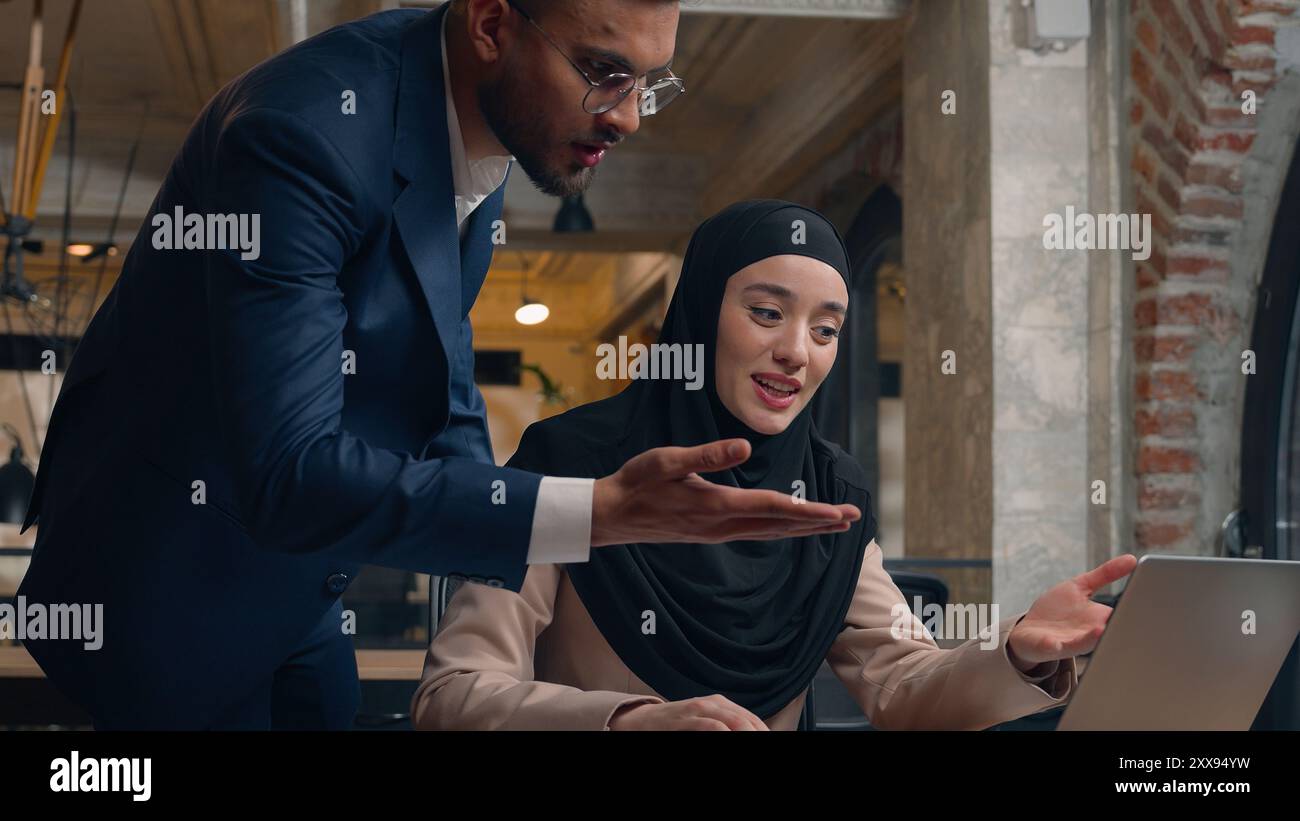 Two business colleagues co-workers talk discuss corporate work at ...