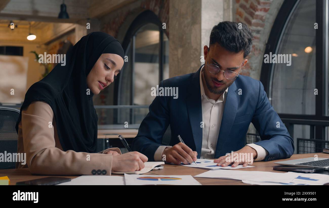 Two business colleagues co-workers talk discuss corporate work at ...