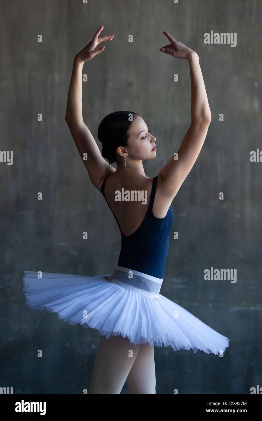 Ballerina in a white tutu poses for the camera Stock Photo - Alamy