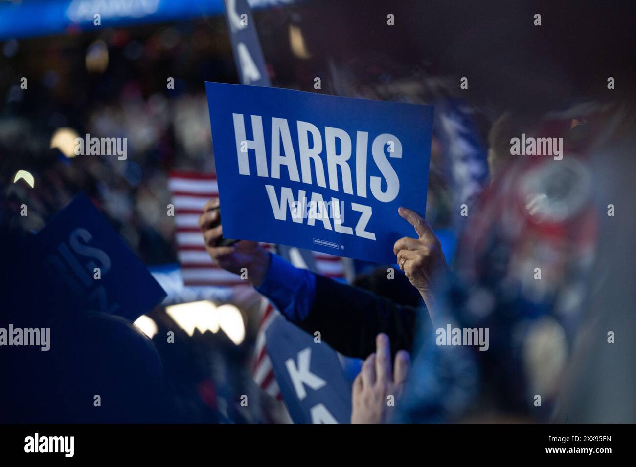 People hold up signs as United States Vice President Kamala Harris, the ...