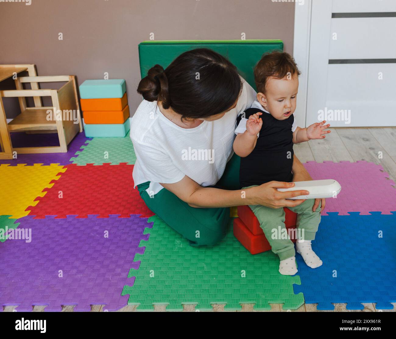 Little boy with hypotonia wearing spine corset practices coordination ...