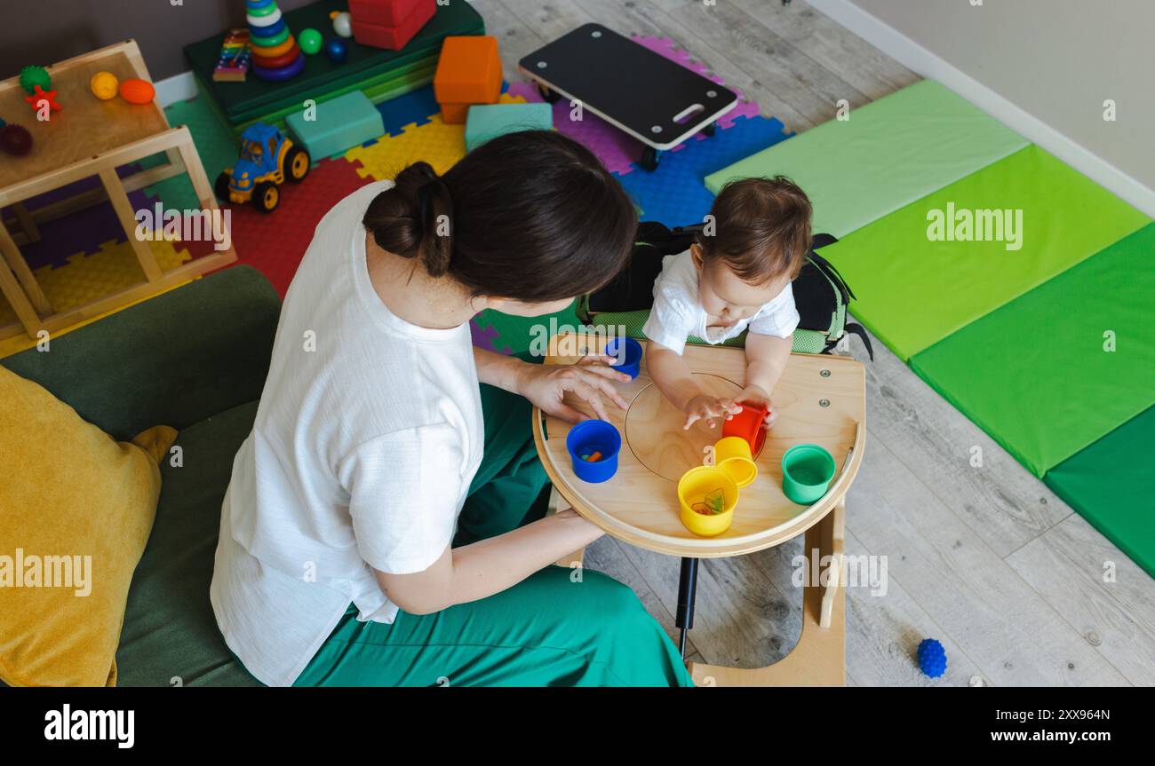 Little boy with musculoskeletal disorders practices his motor skills ...
