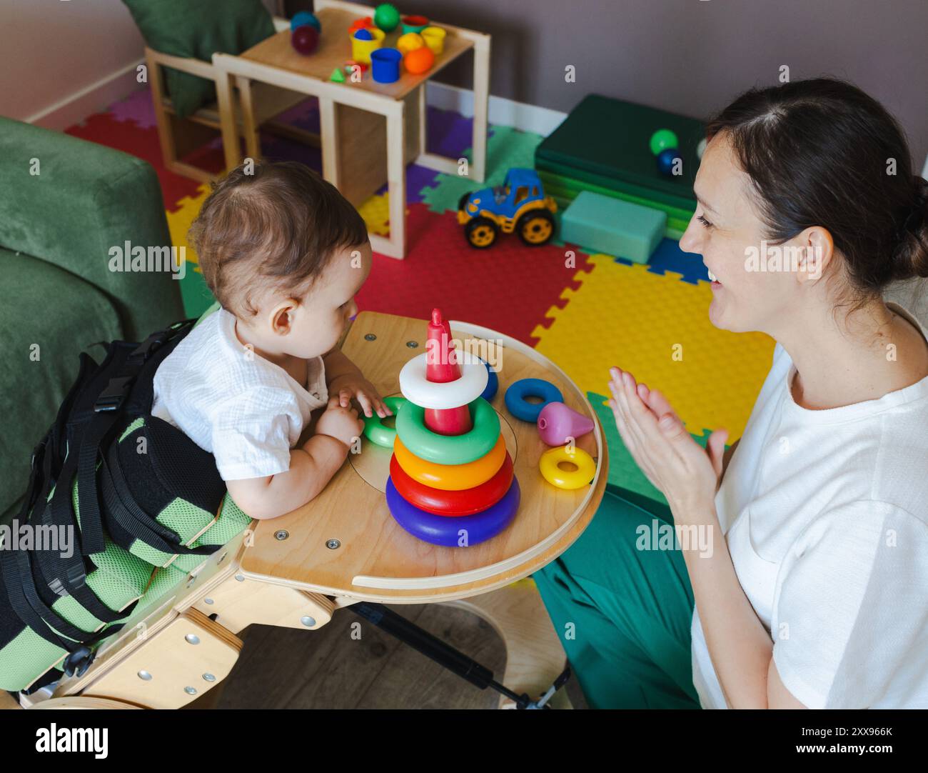 Little boy with body hypotonia is working on motor skills standing ...