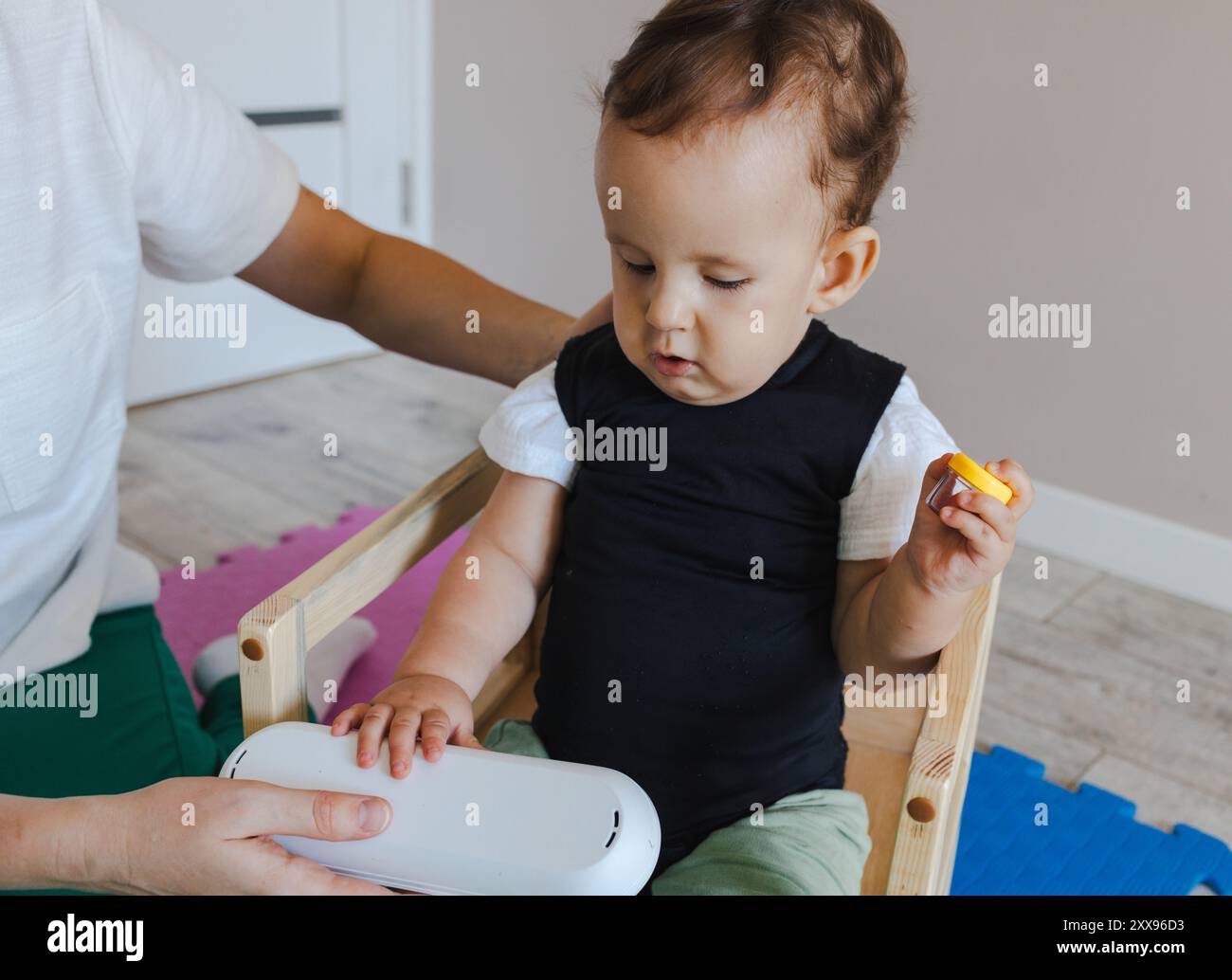Cute little boy wearing rehab corset engages in physical therapy ...