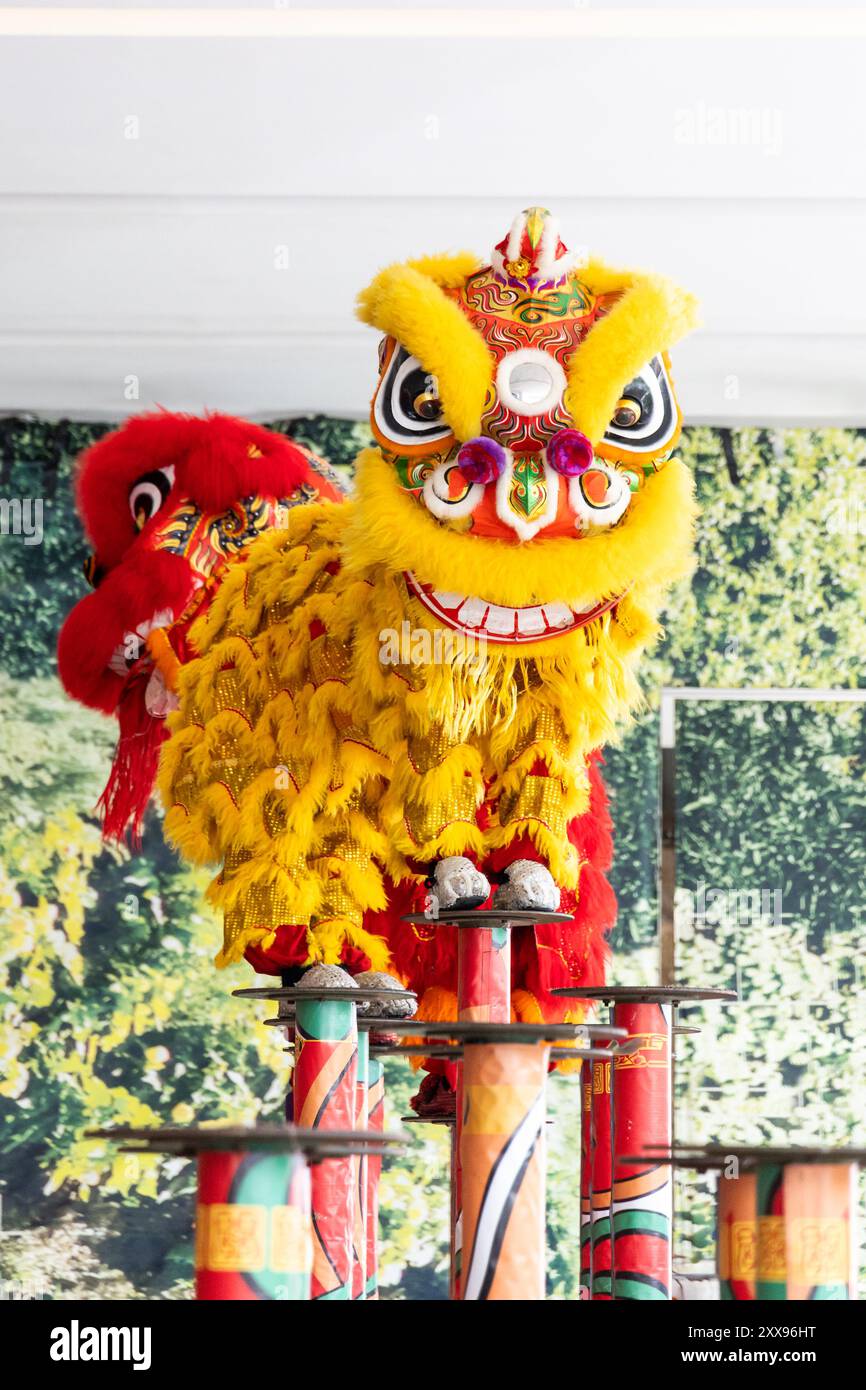Two lions performing dances on pillars as part of Chinese cultural ...