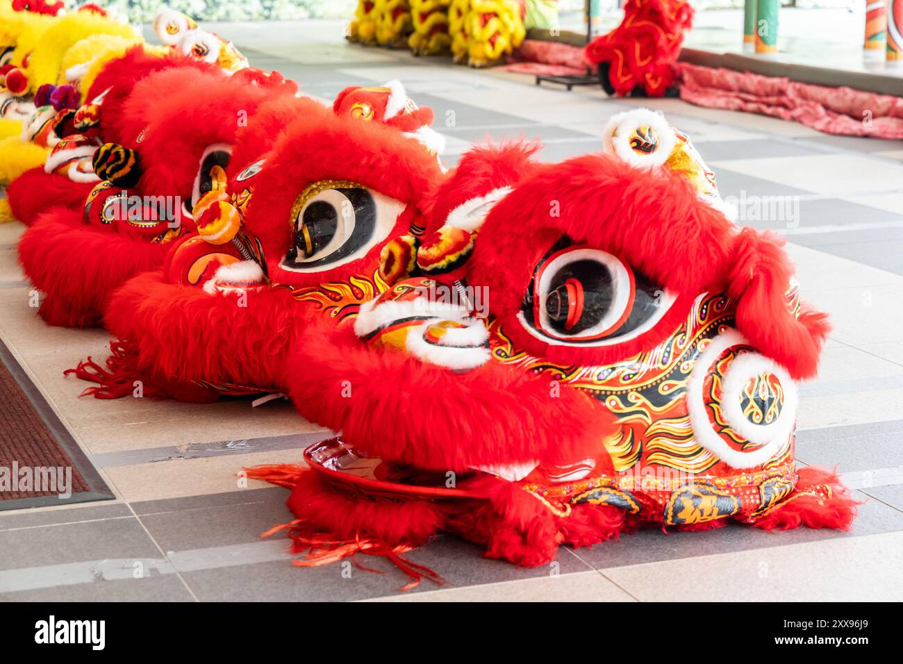 Lion head costume for traditional Chinese Lion dance laid in a row ...