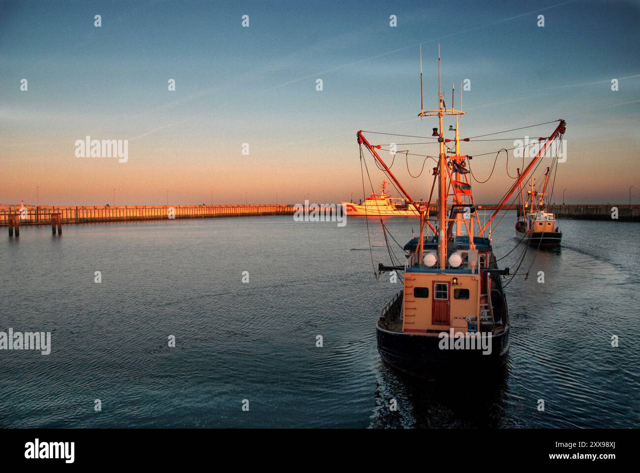 Heligoland, Germany. Fishing boat leaving the harbour. March 3rd 2013 ...