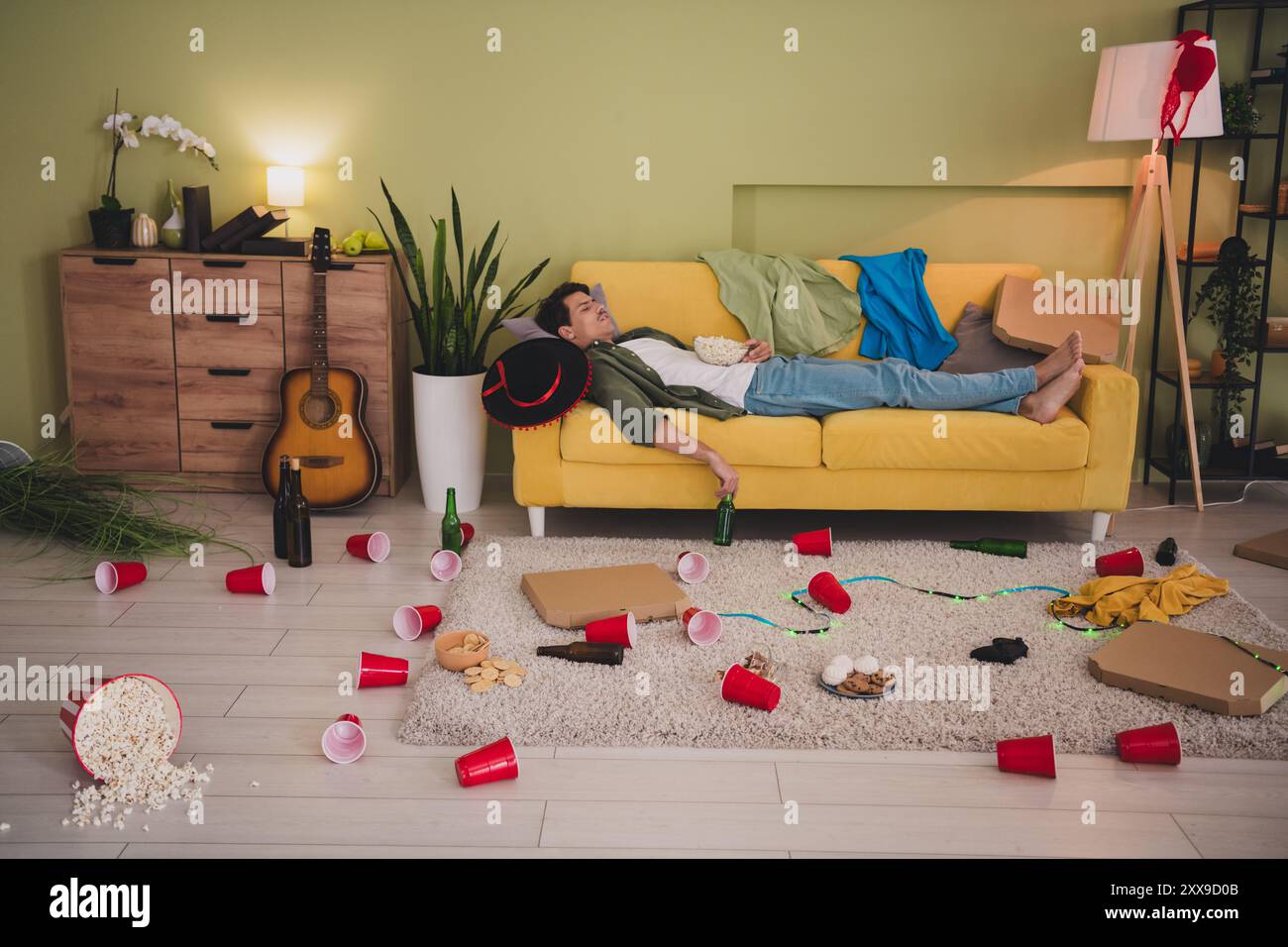 Photo of funny young man indoors house home living room relax rest ...