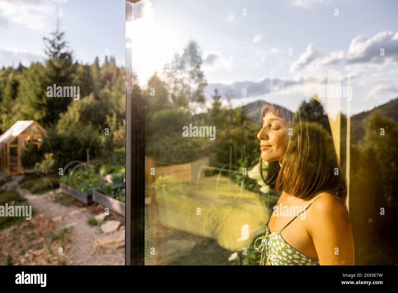 Woman Reflecting by the Window of a Modern House in Nature Stock Photo ...