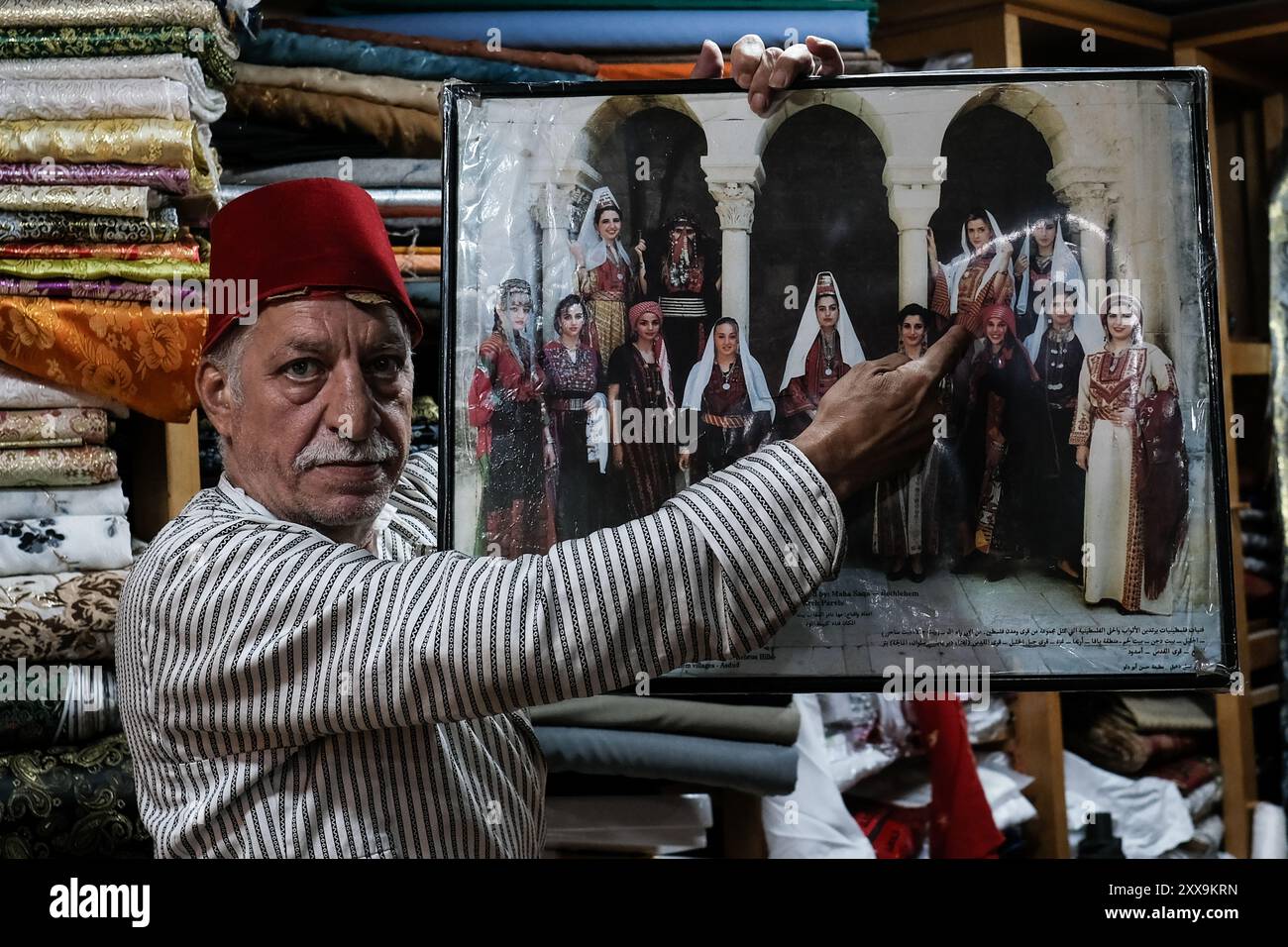 Jerusalem textile merchant Bilal Abu Khalaf stands in his shop in the ...
