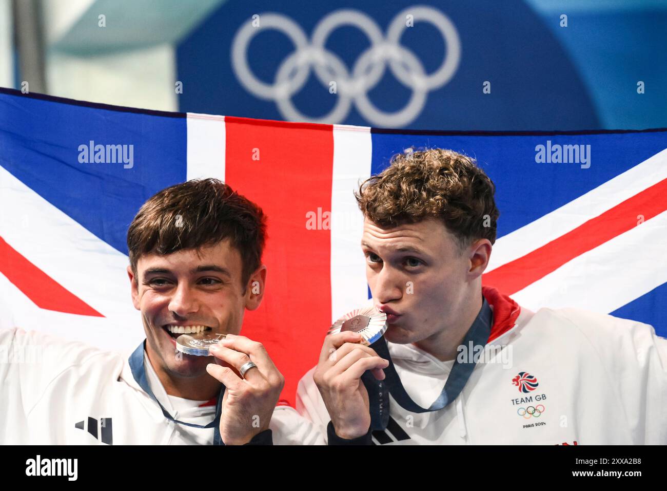 Thomas Daley and Noah Williams of Great Britain bite the silver medals ...
