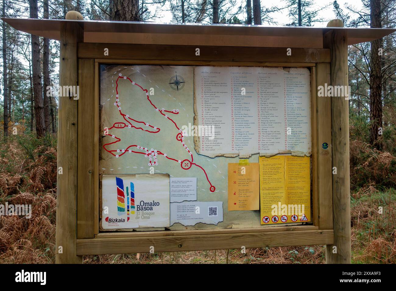Visitor information board at El Bosque de Oma, a forest with painted ...