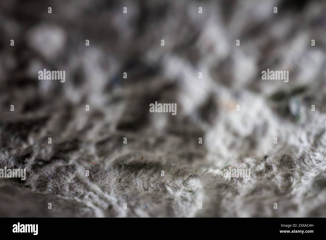 Extreme close up of old gray handmade paper mache with a structure and ...
