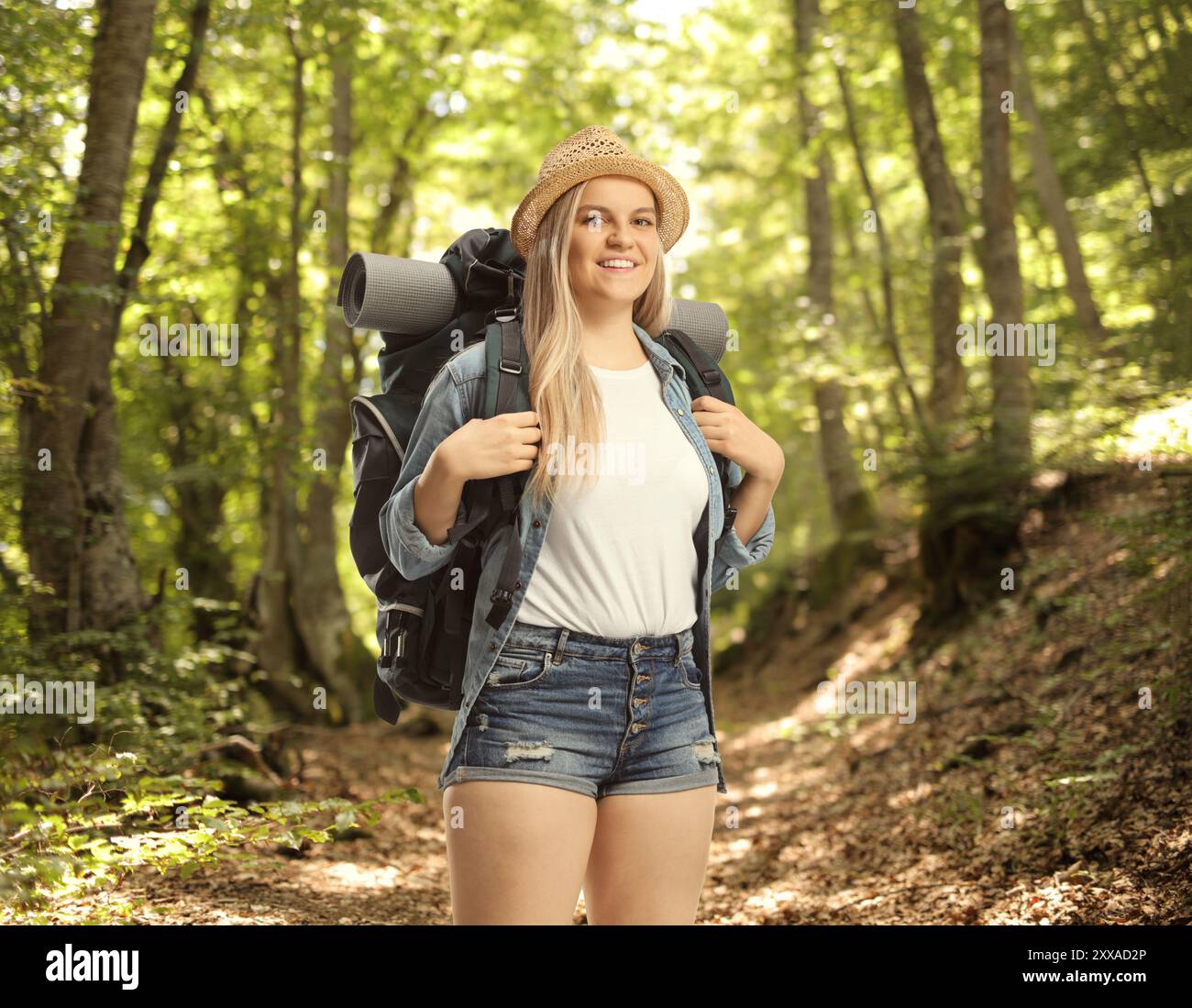 Young female backpacker posing in a forest Stock Photo - Alamy