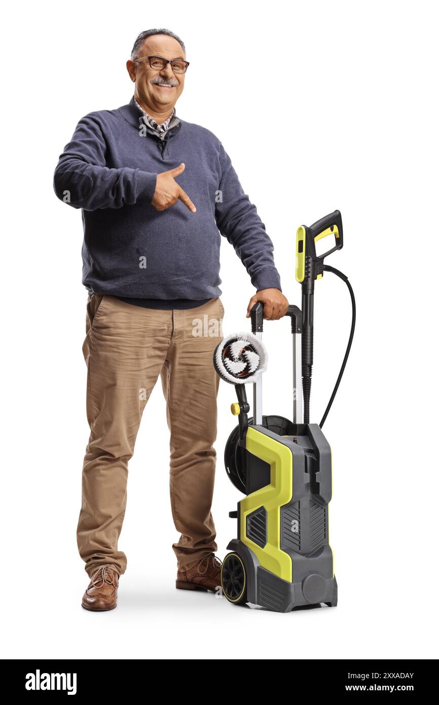 Mature man pointing at a high pressure washer machine isolated on white ...