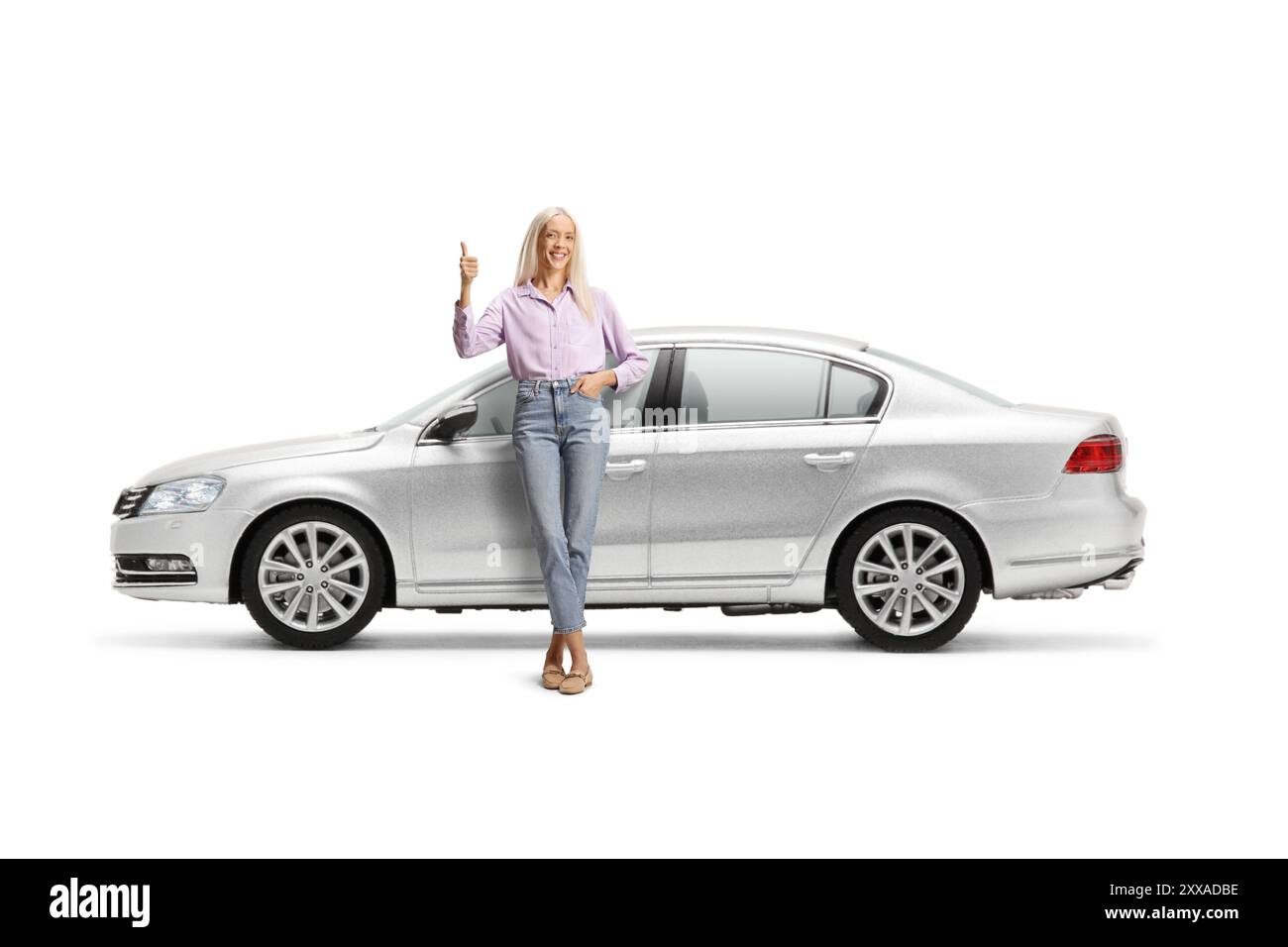 Woman car owner leaning on a silver car and pointing up isolated on ...