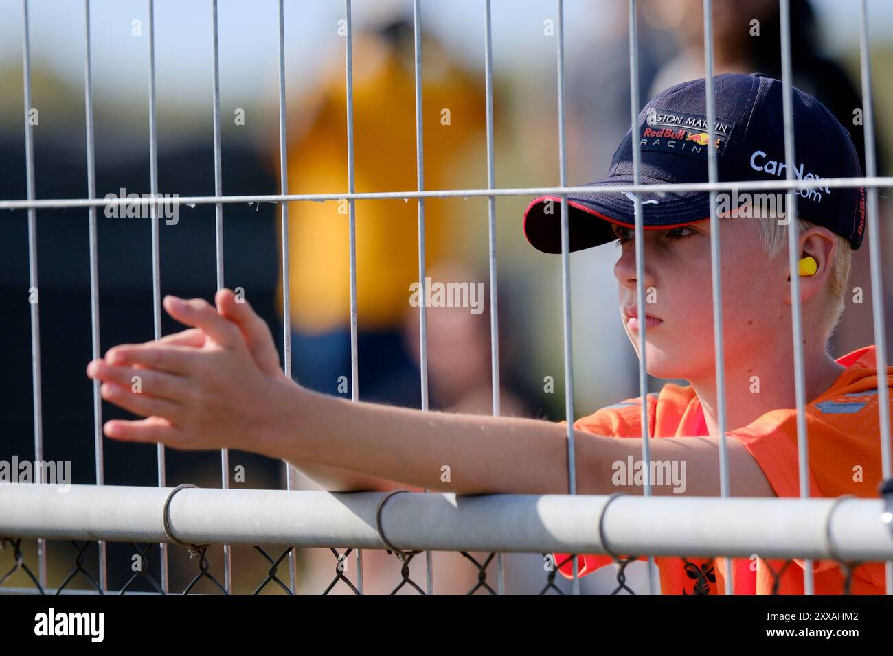 A young fan watches from behind a fence barrier during the second ...