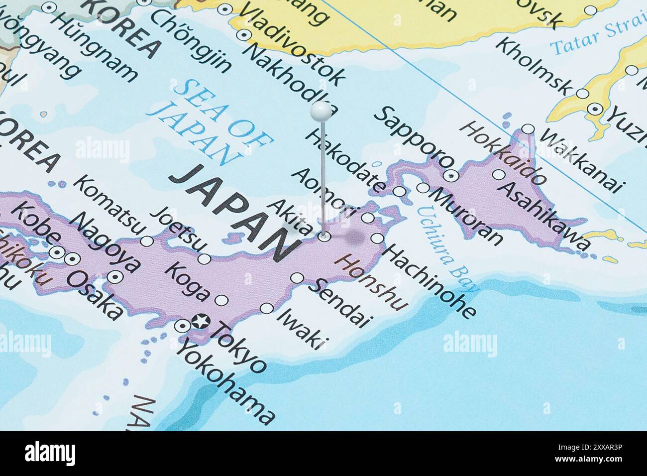 Close up to a Akita city with a white pin needle into Japan country ...