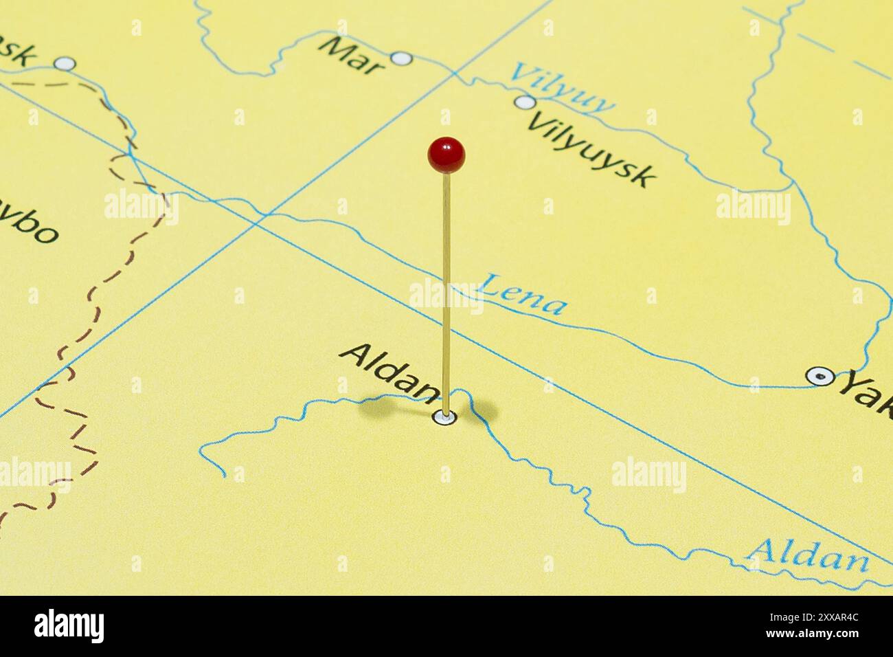 Close up to a Aldan city with a red pin needle into Russia country ...