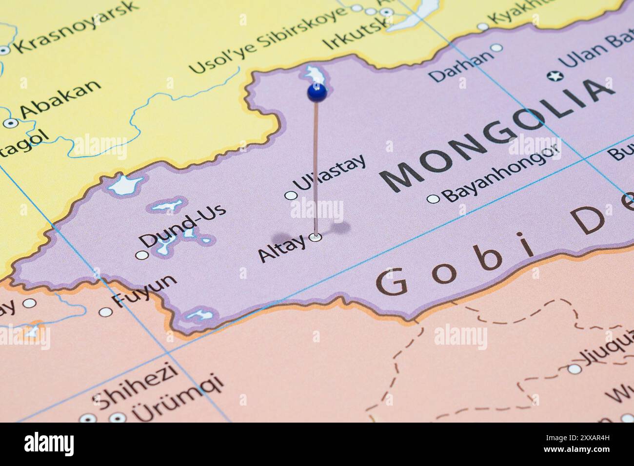 Close up to a Altai city with a blue pin needle into Mongolia country ...