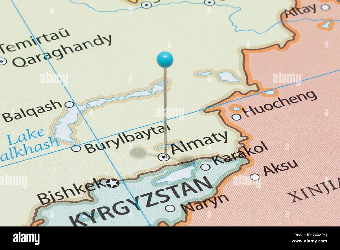 Close up to a Almatу city with a light blue pin needle into Kazakhstan ...