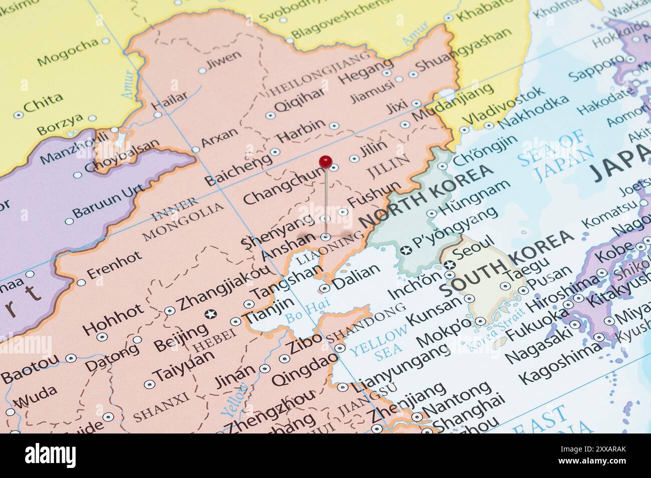 Close up to a Anshan city with a red pin needle into China country ...