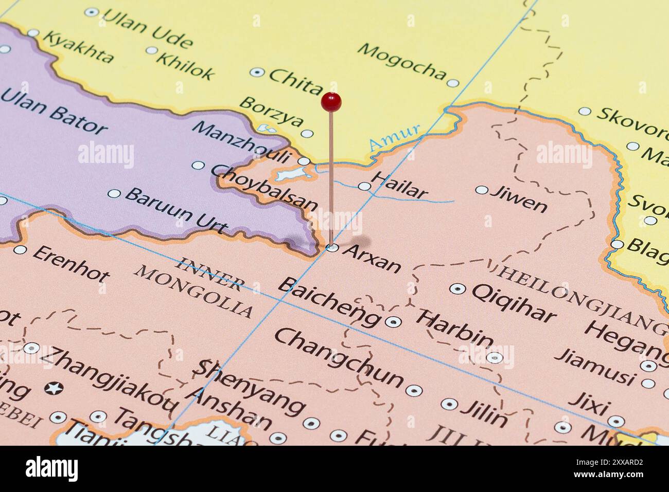 Close up to a Arxan city with a red pin needle into China country ...