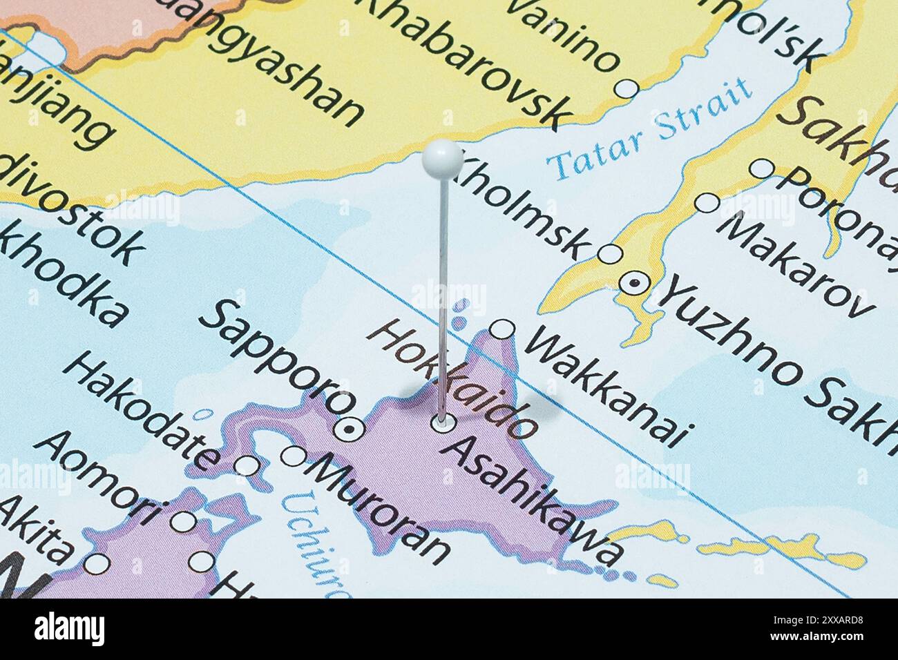 Close up to a Asahikawa city with a white pin needle into Japan country ...