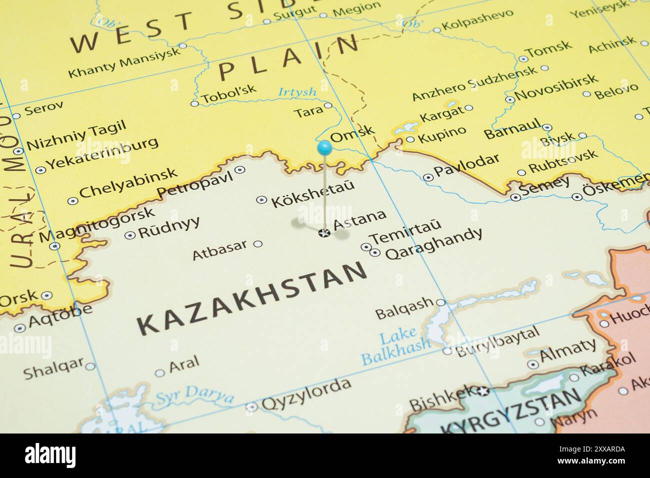 Close up to a Astana city with a light blue pin needle into Kazakhstan ...
