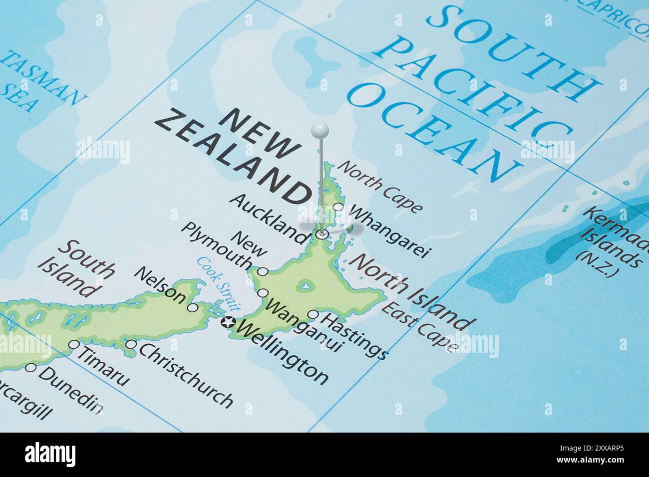 Close up to a Auckland city with a white pin needle into New Zealand ...