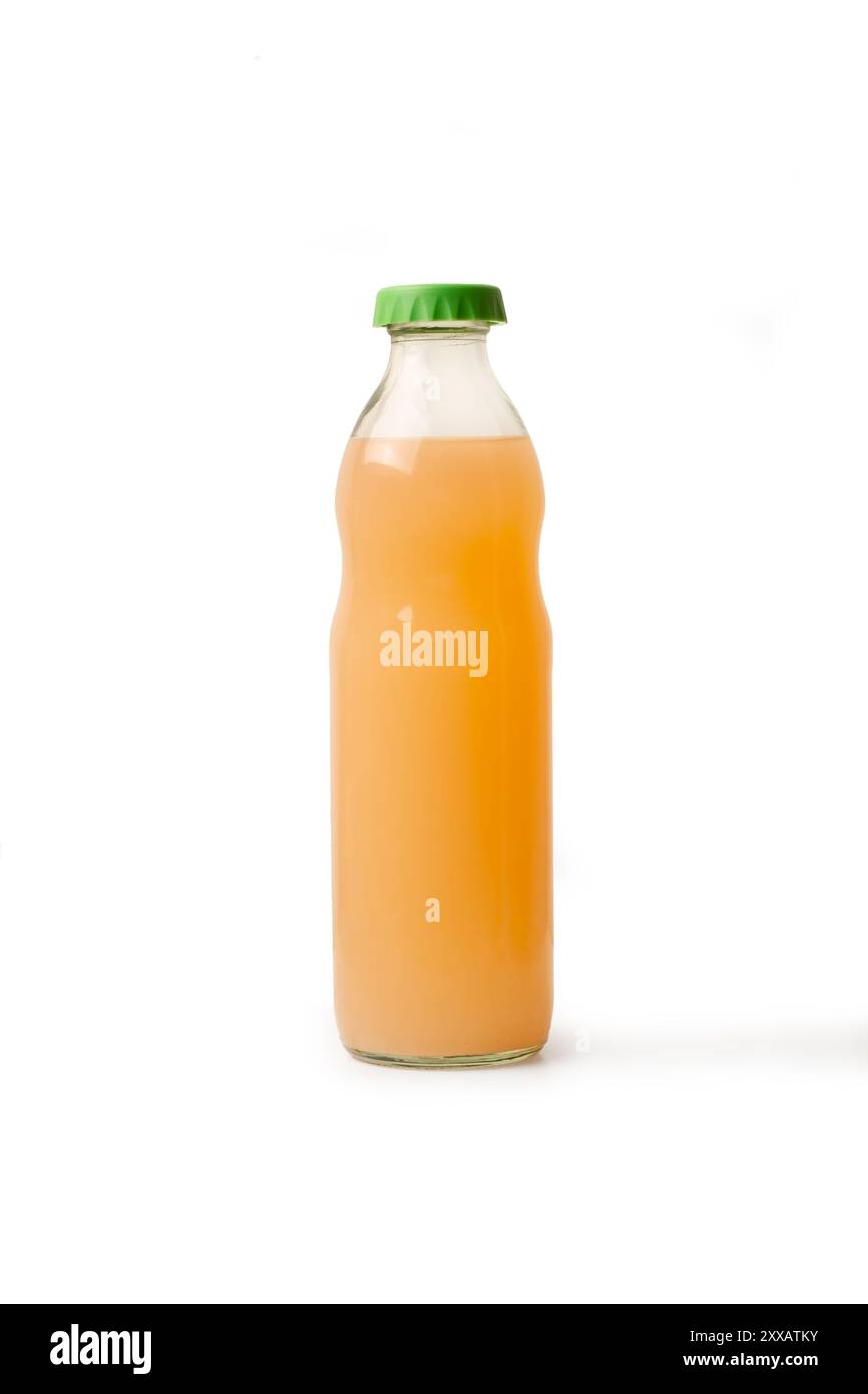 A bottle of grapefruit juice with a green cap on a white background ...