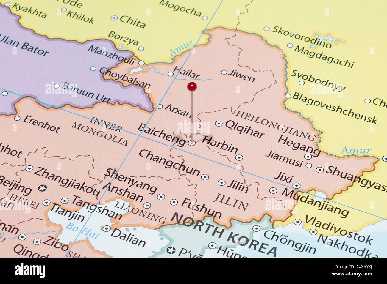 Close up to a Baicheng city with a red pin needle into China country ...