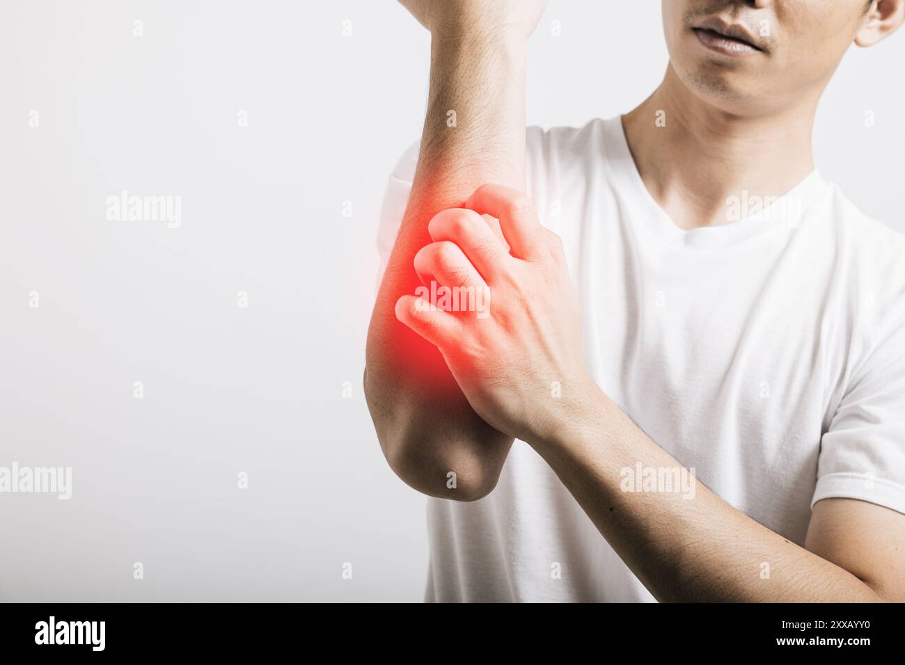 Portrait of an unhappy man scratching his arm Stock Photo - Alamy