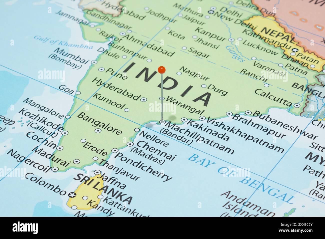 Close up to a Bandar city with an orange pin needle into India country ...