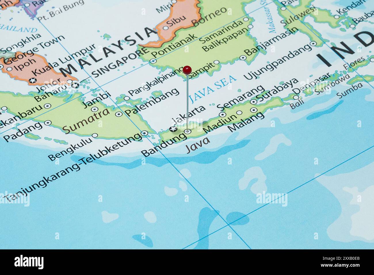 Close up to a Bandung city with a red pin needle into Indonesia country ...