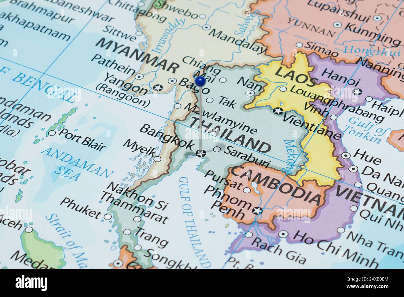 Close up to Bangkok city with a blue pin needle into Thailand country ...