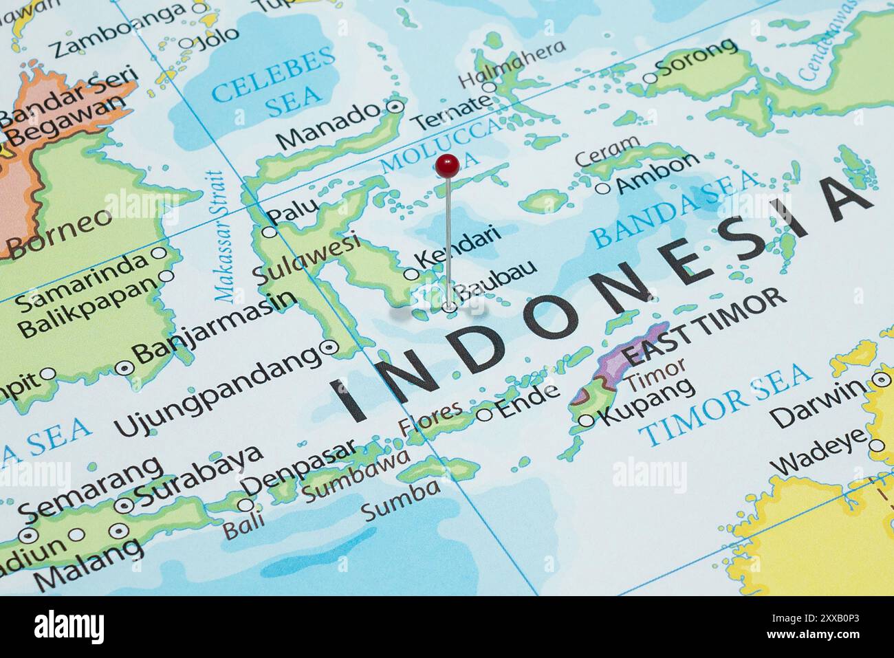 Close up to a Baubau city with a red pin needle into Indonesia country ...