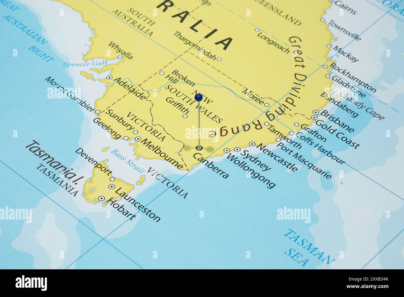 Close up to a Canberra city with a blue pin needle into Australia ...