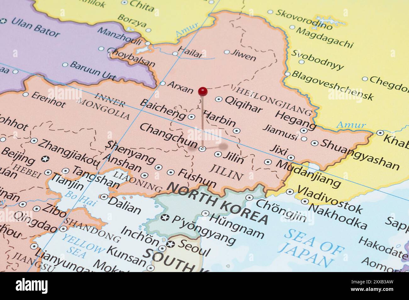 Close up to a Changchun city with a red pin needle into China country ...