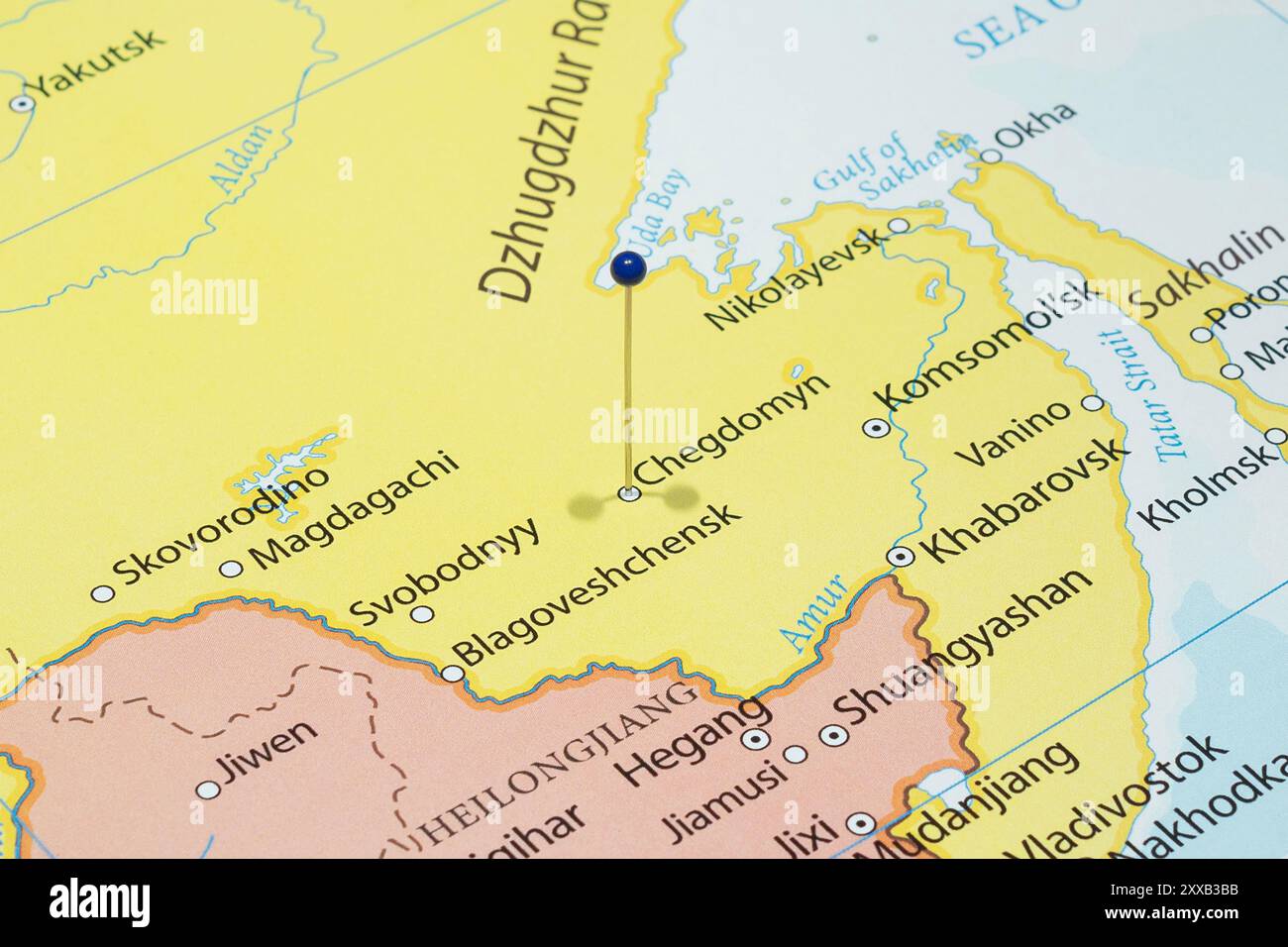 Close up to a Chegdomyn city with a blue pin needle into Russia country ...