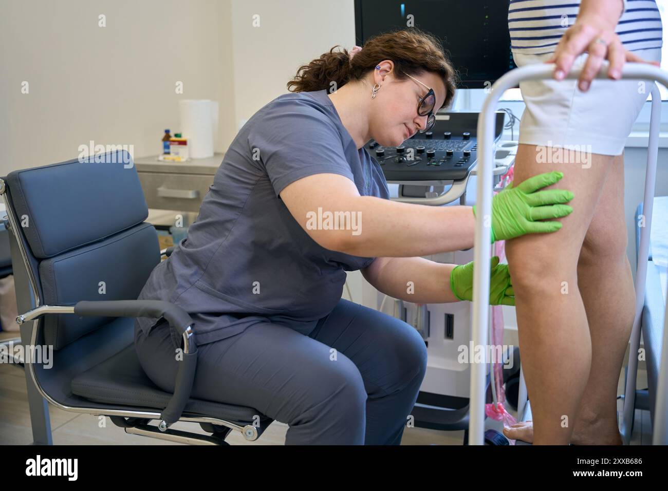 Female phlebologist uses a modern ultrasound machine in her work Stock ...